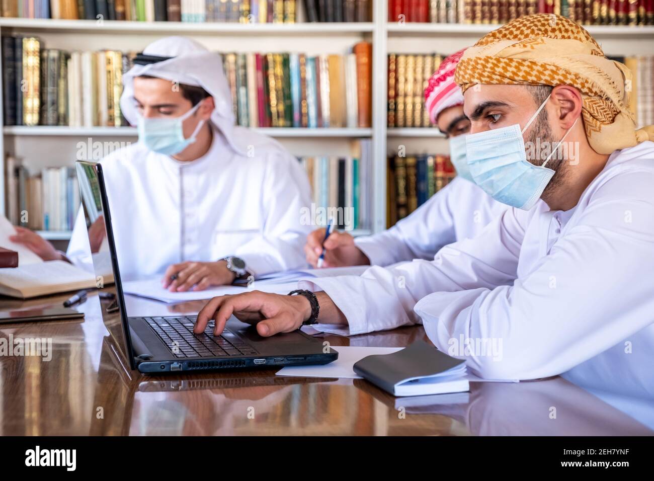 Arabic guys studying for exam together wearing protection masks Stock ...