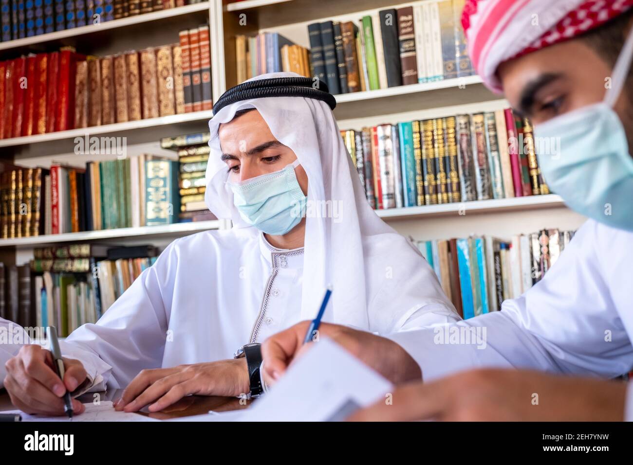 Arabic guys studying for exam together wearing protection masks Stock ...