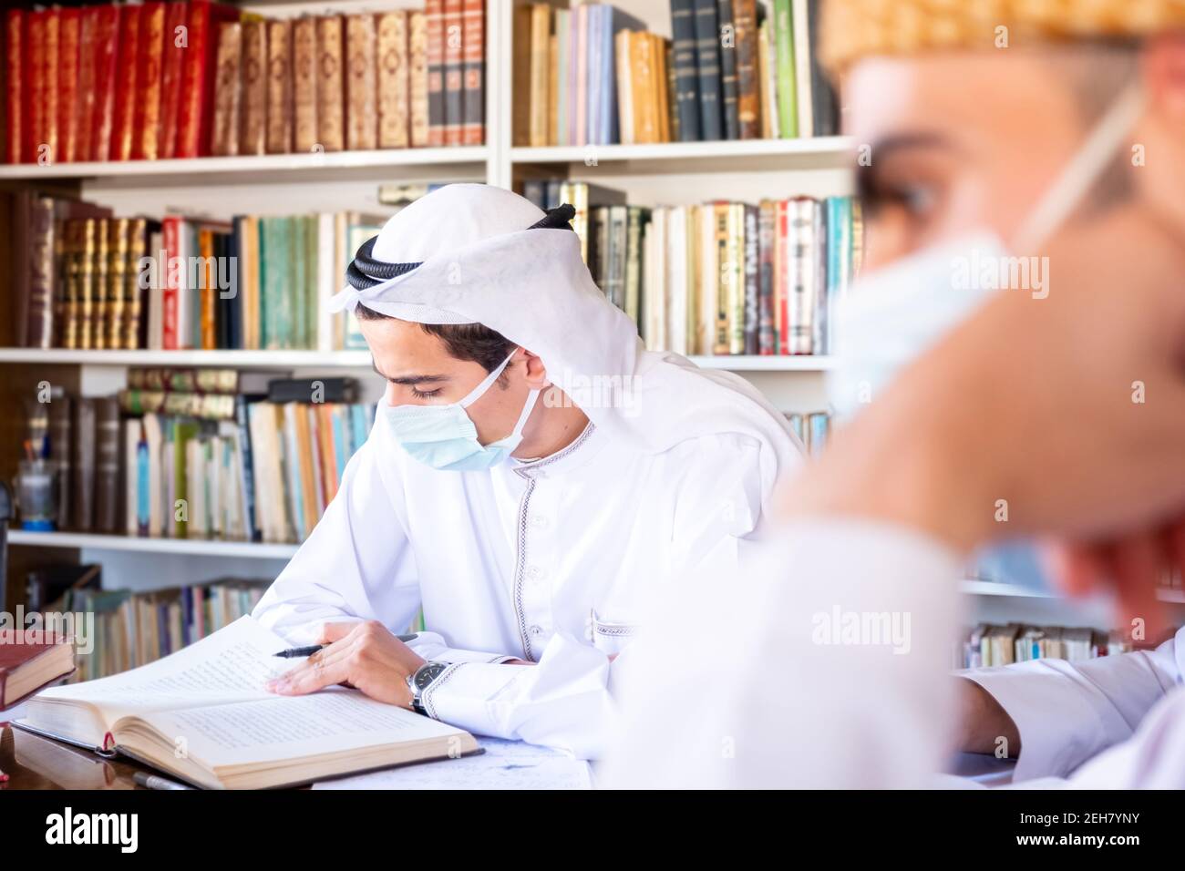 Arabic guys studying for exam together wearing protection masks Stock ...