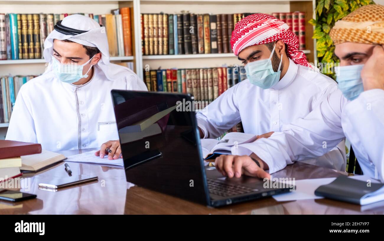 Arabic guys studying for exam together wearing protection masks Stock ...