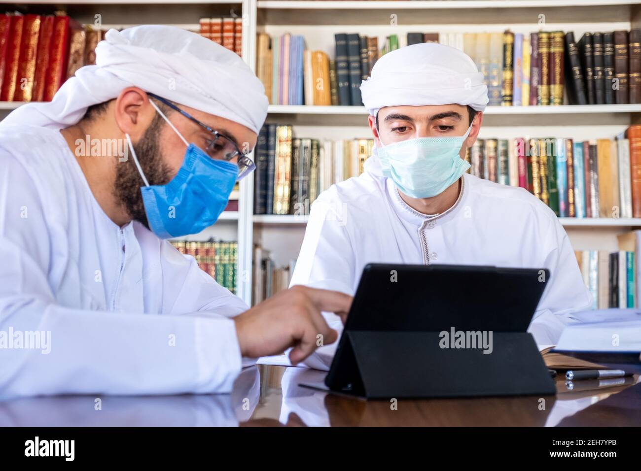 Arabic guys studying for exam together wearing protection masks Stock ...