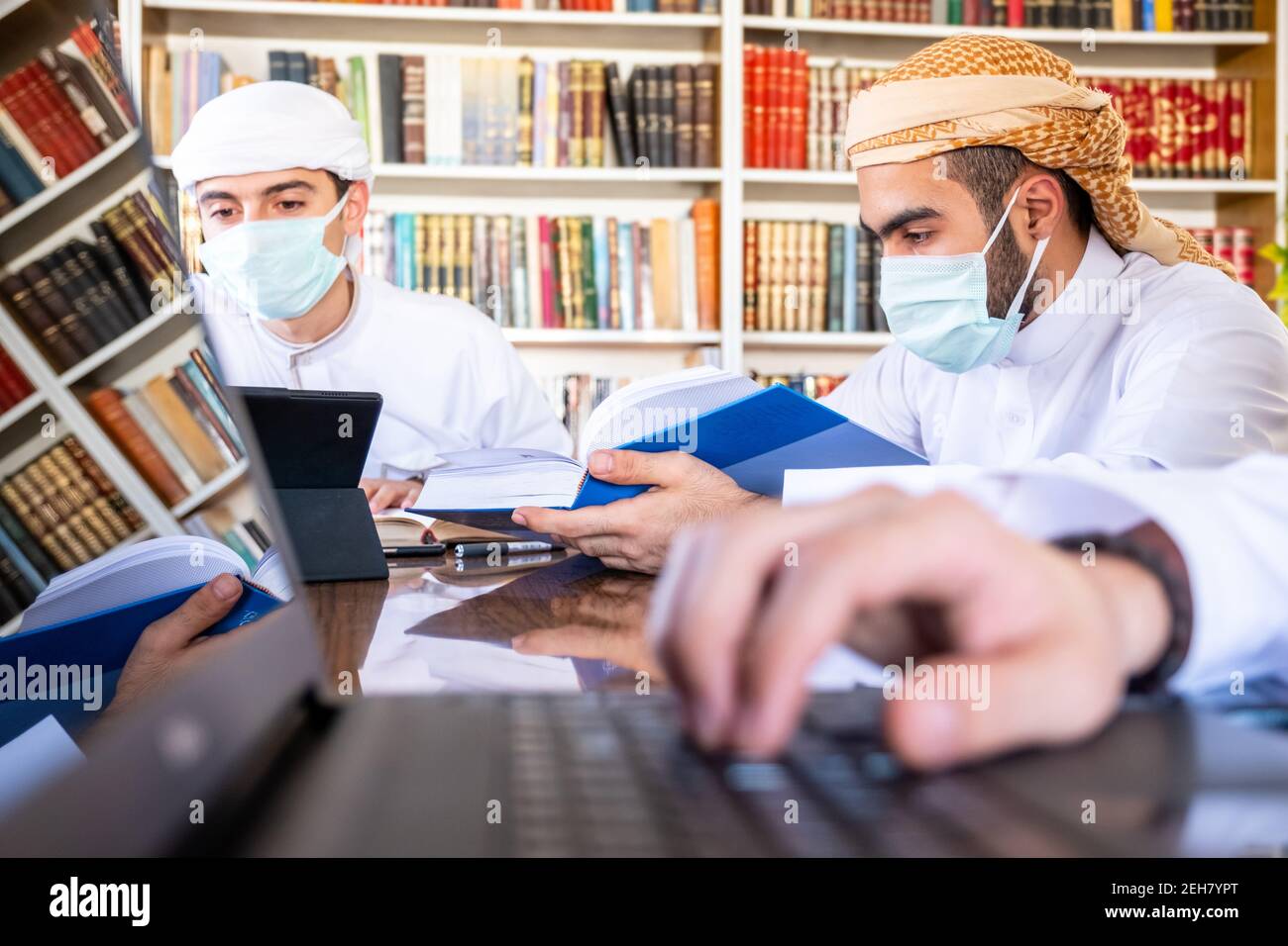 Arabic guys studying for exam together wearing protection masks Stock ...