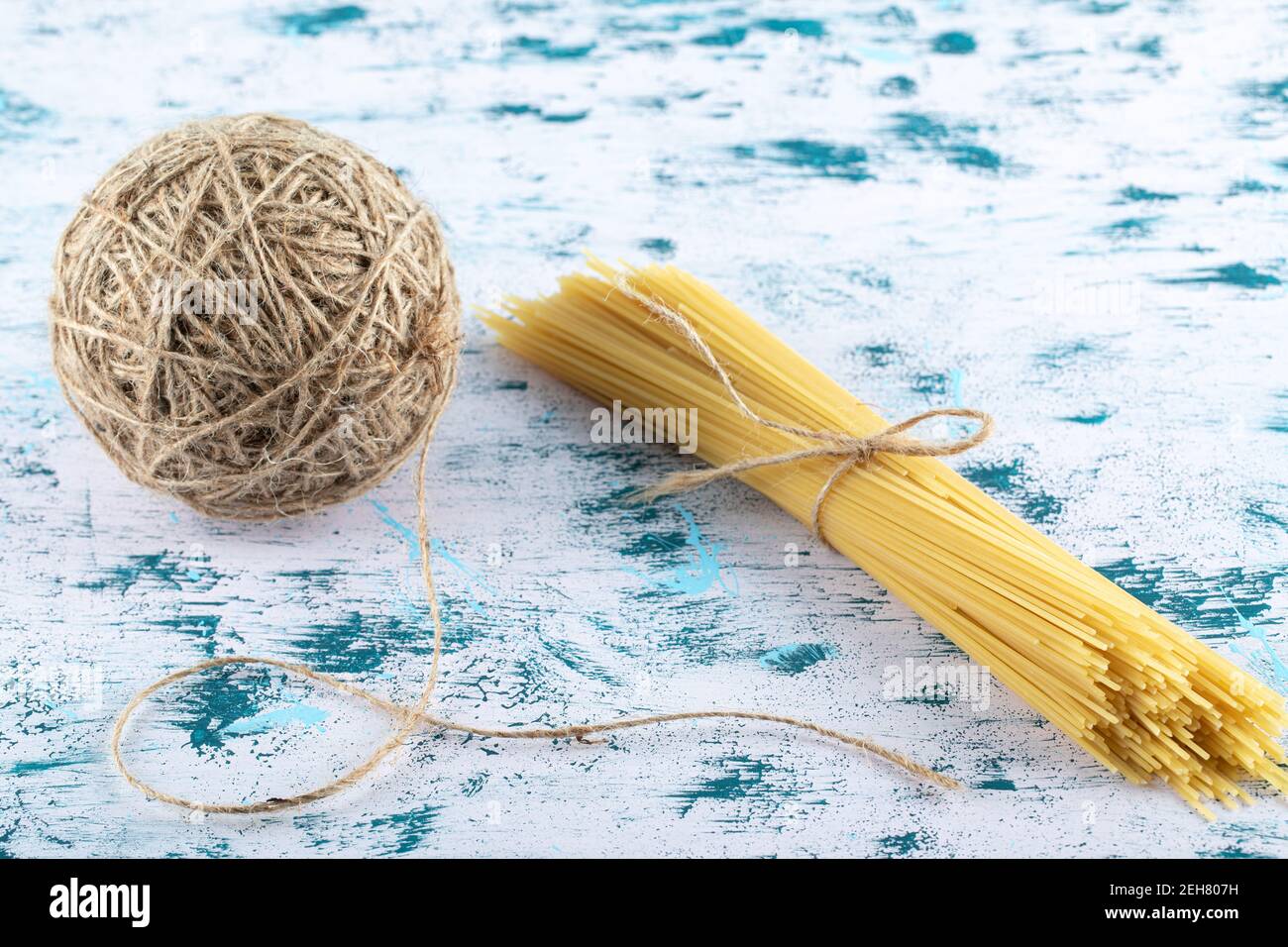 Raw spaghetti on blue hi-res stock photography and images - Alamy