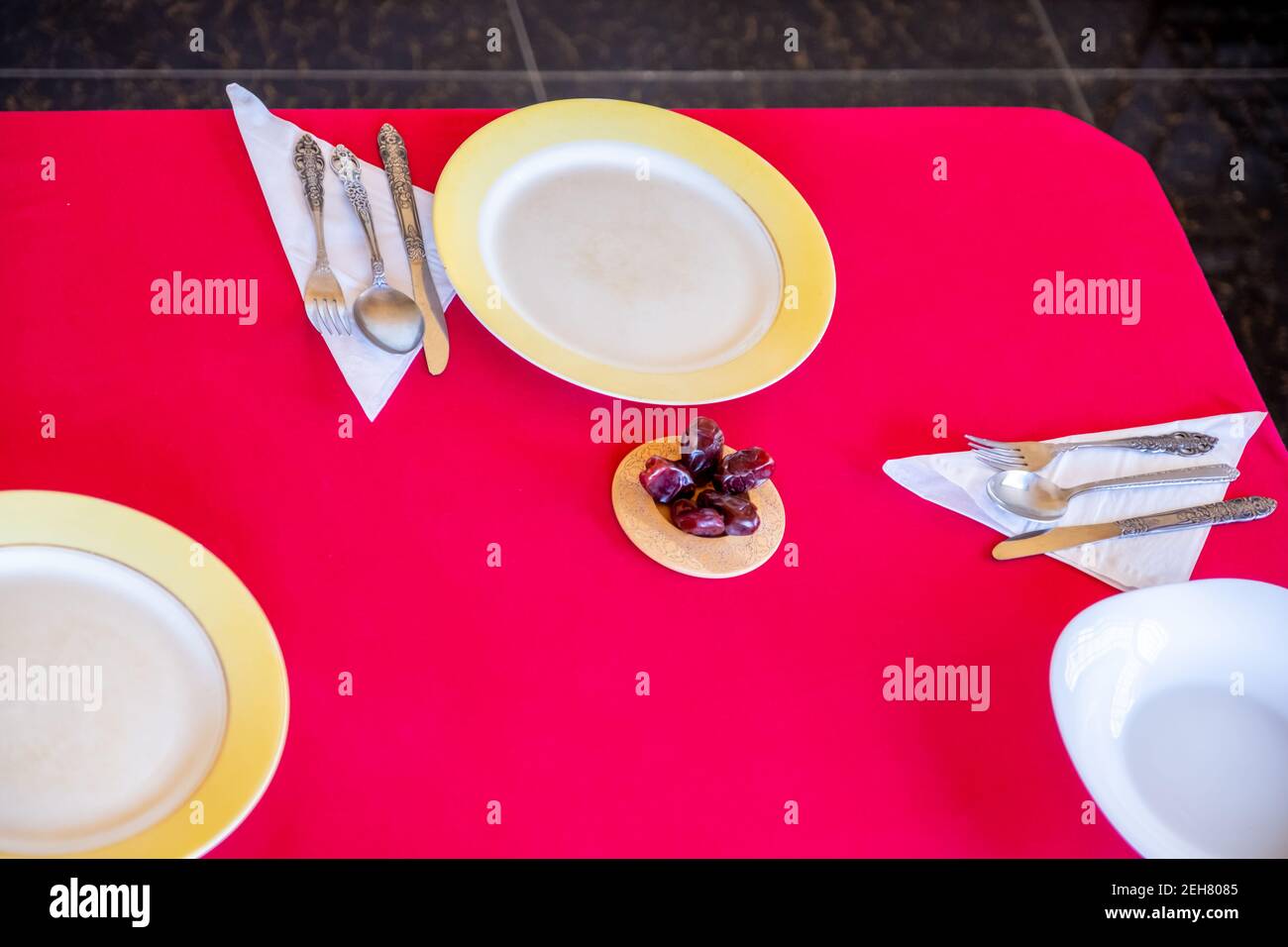 Table with empty plates being prepared for ramadan iftar Stock Photo ...