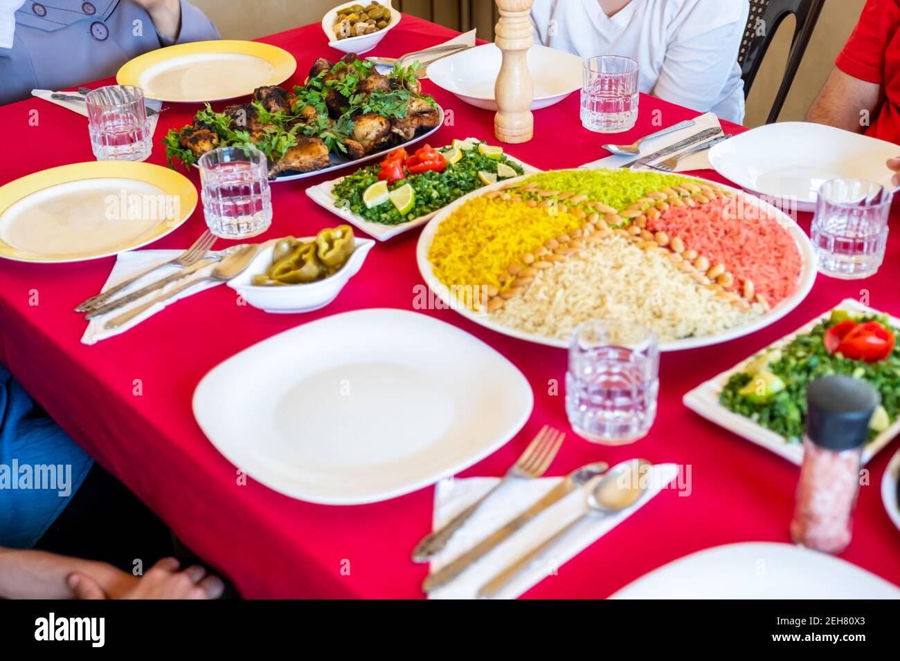 Happy arabic muslim family eating together in a family meeting for ...