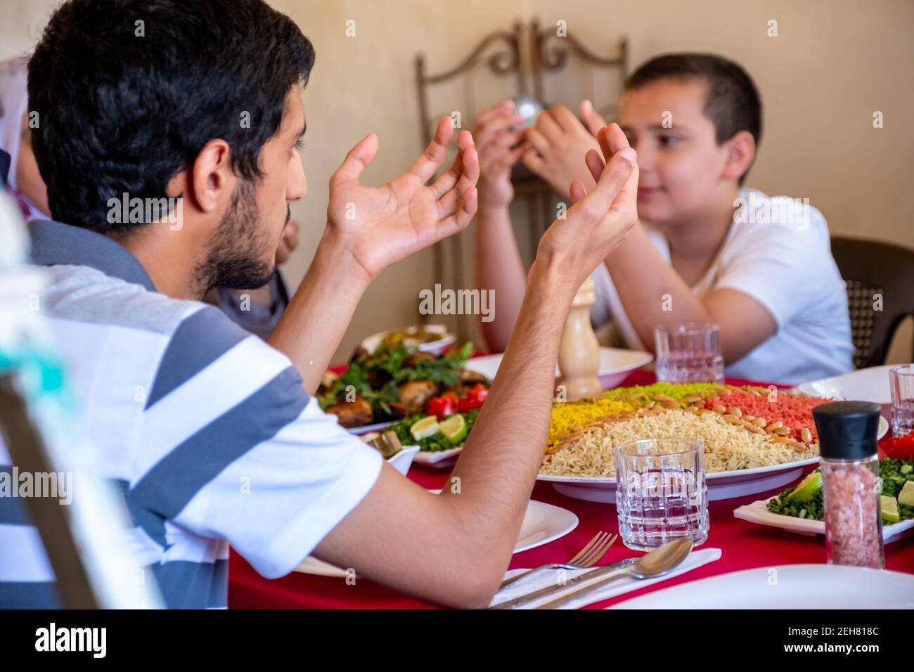 Arabic muslim family praying for god before eating iftar Stock Photo ...