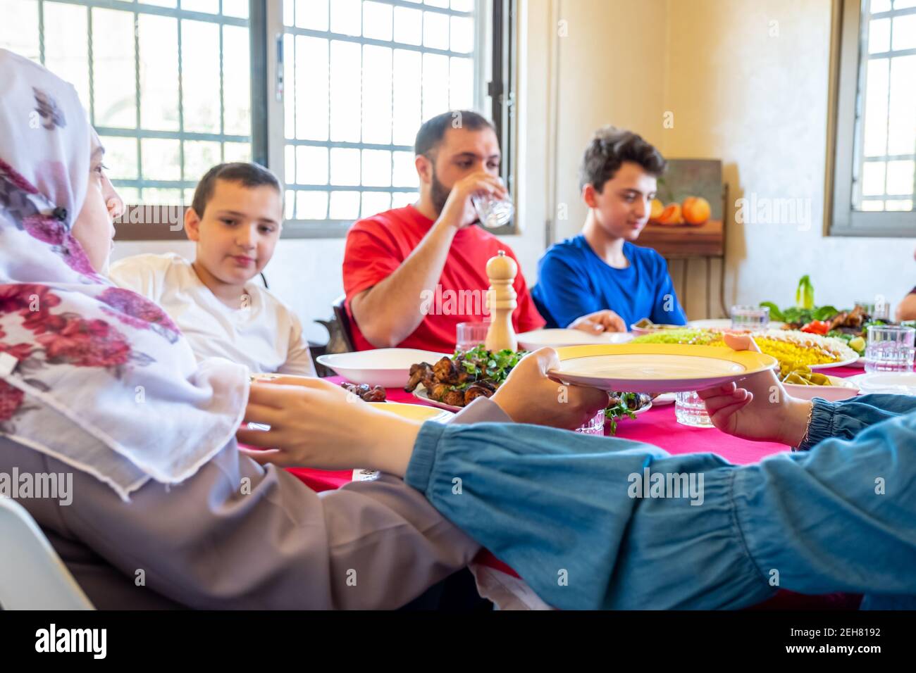 Arabic muslim family eating together in a meeting for iftar in ramdan ...