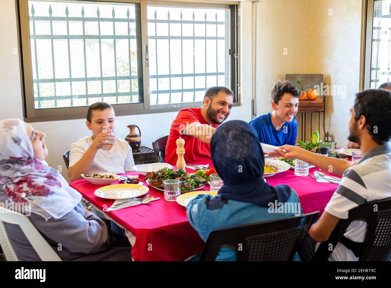 Arabic muslim family eating together in a meeting for iftar in ramdan ...
