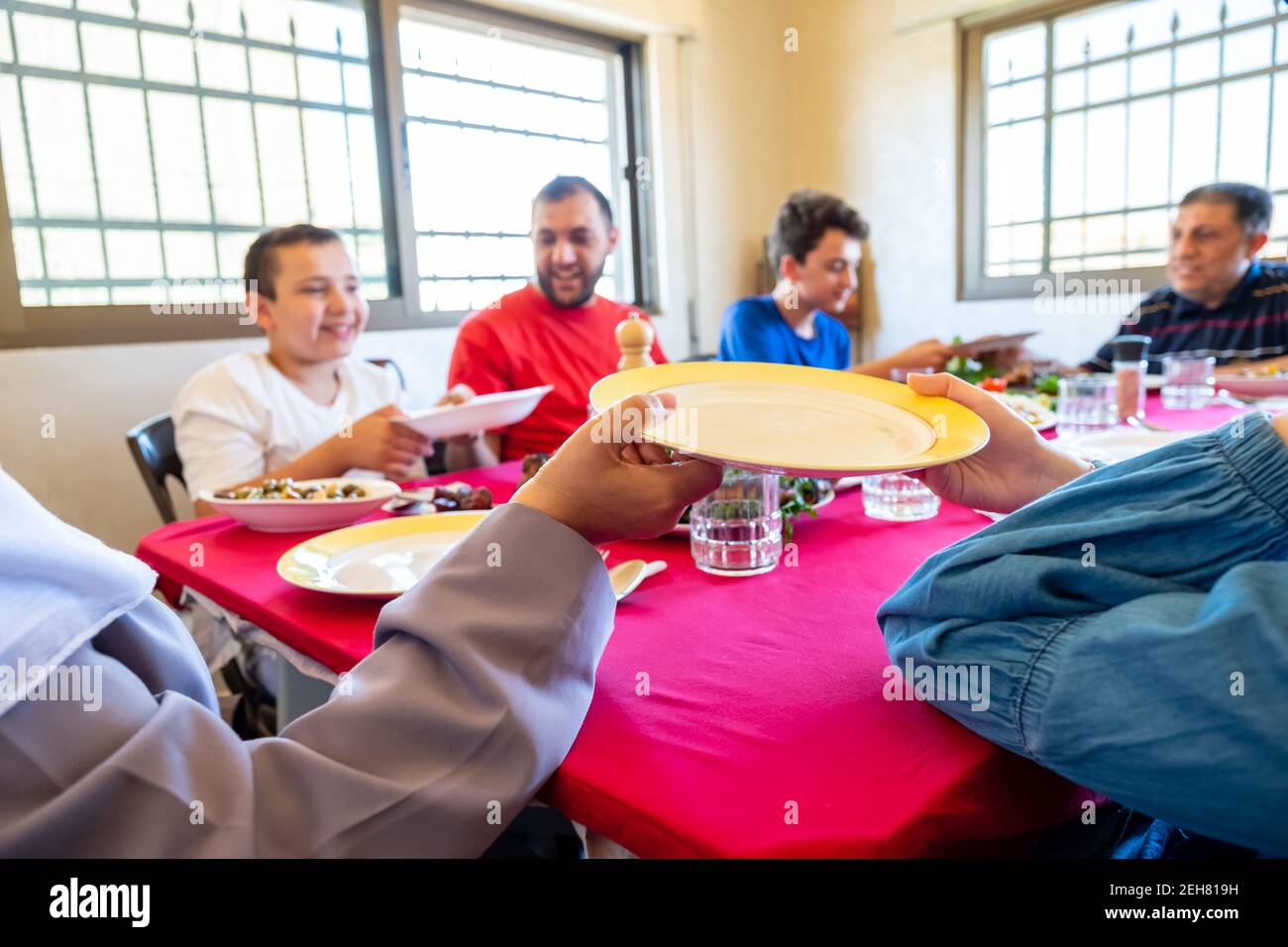 Arabic muslim family eating together in a meeting for iftar in ramdan ...