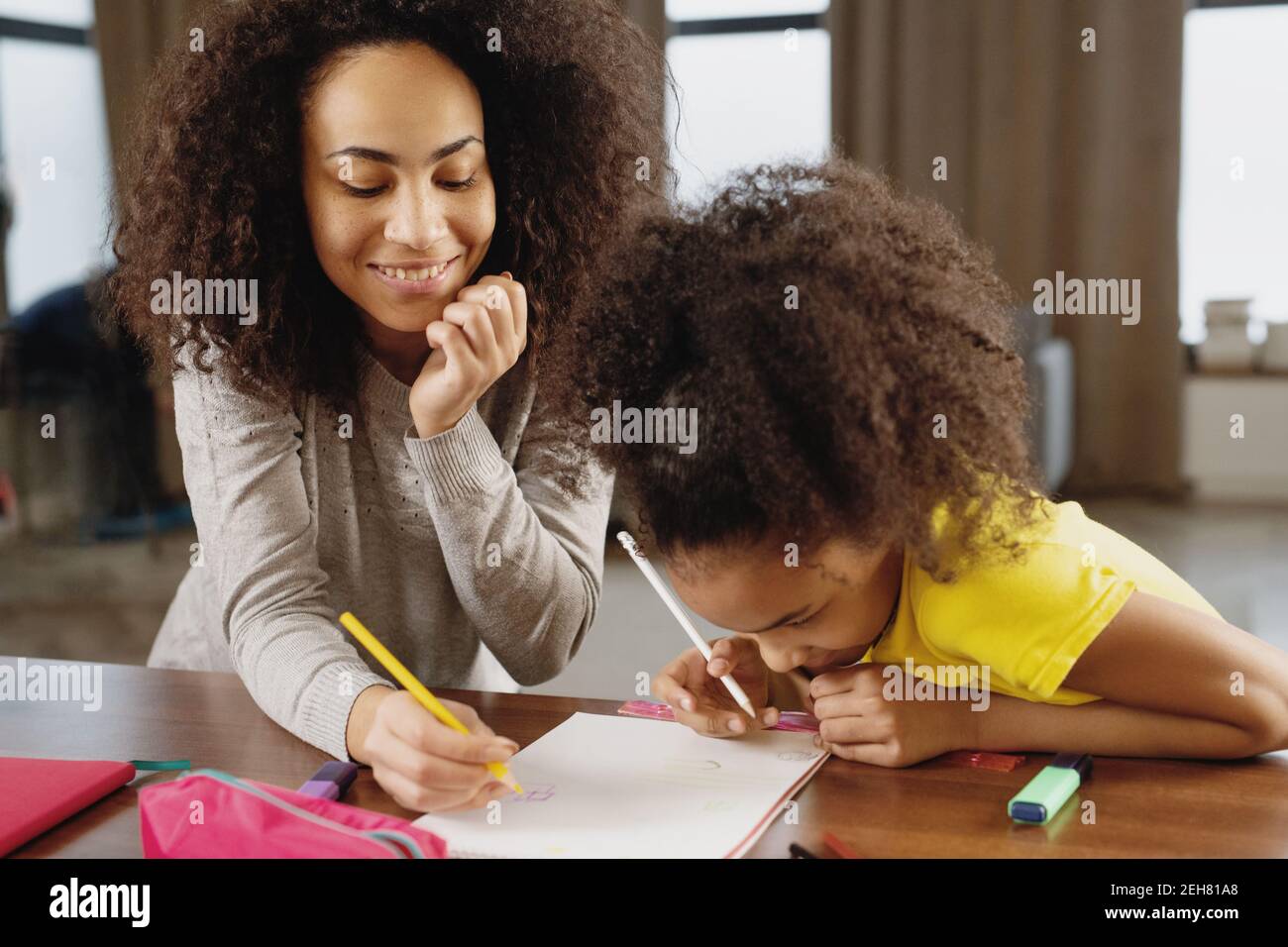 Mother and daughter doing homework together at home Stock Photo - Alamy
