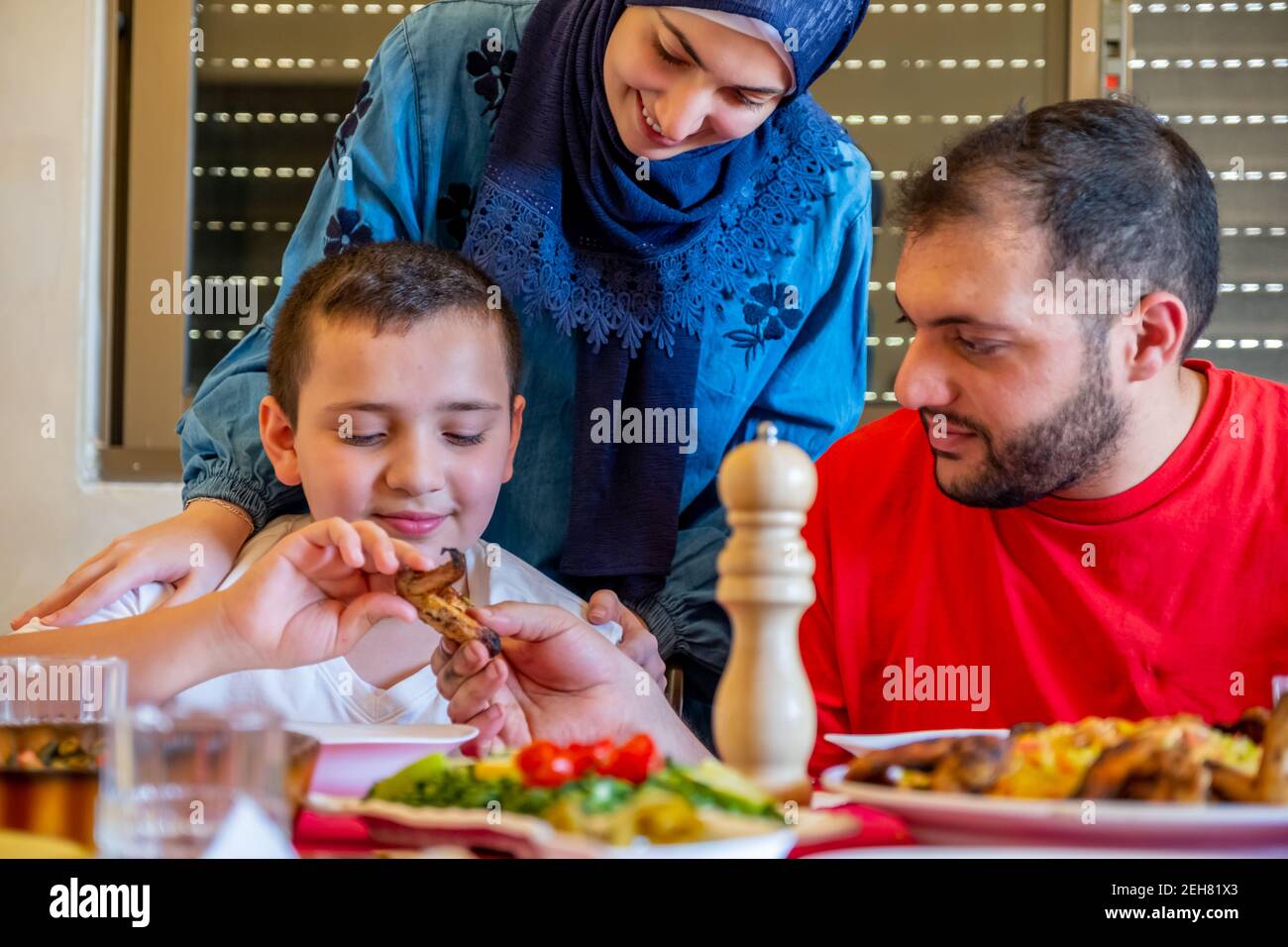 Arabic muslim family eating together in a meeting for iftar in ramdan ...