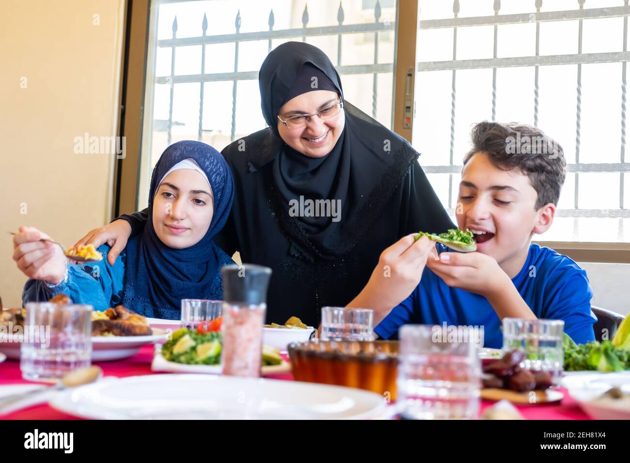 Arabic muslim family eating together in a meeting for iftar in ramdan ...