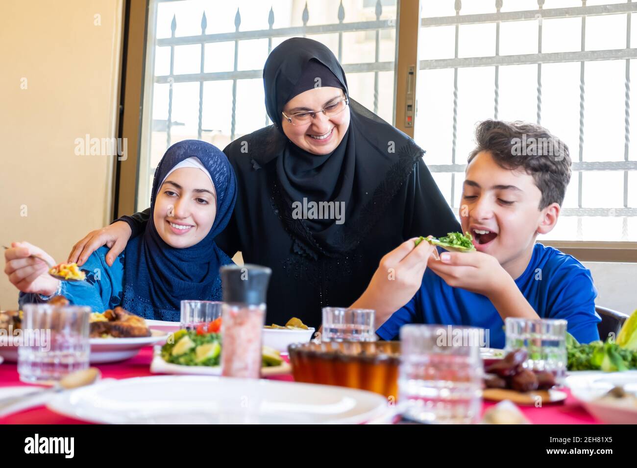 Arabic muslim family eating together in a meeting for iftar in ramdan ...