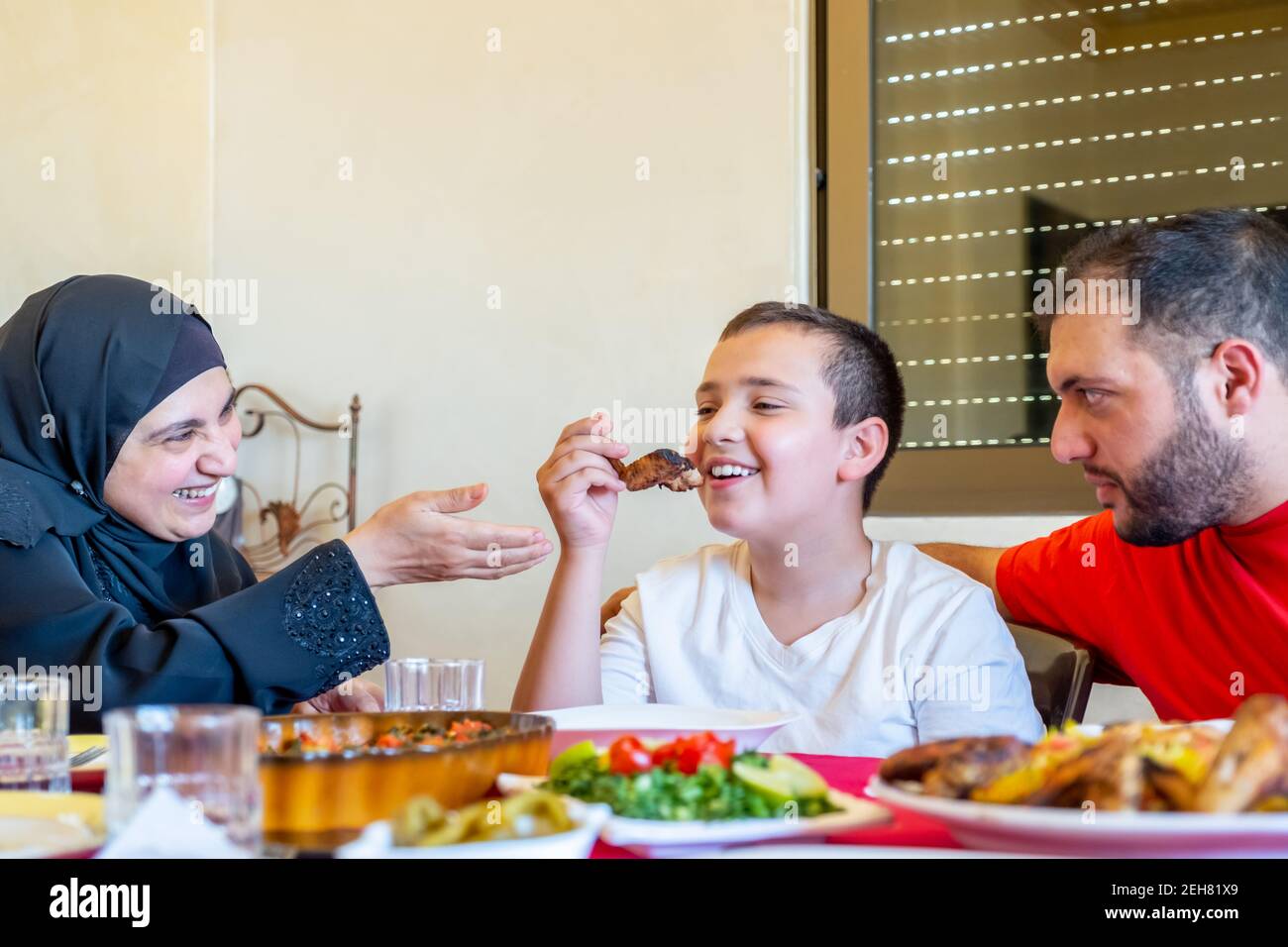 Arabic muslim family eating together in a meeting for iftar in ramdan ...