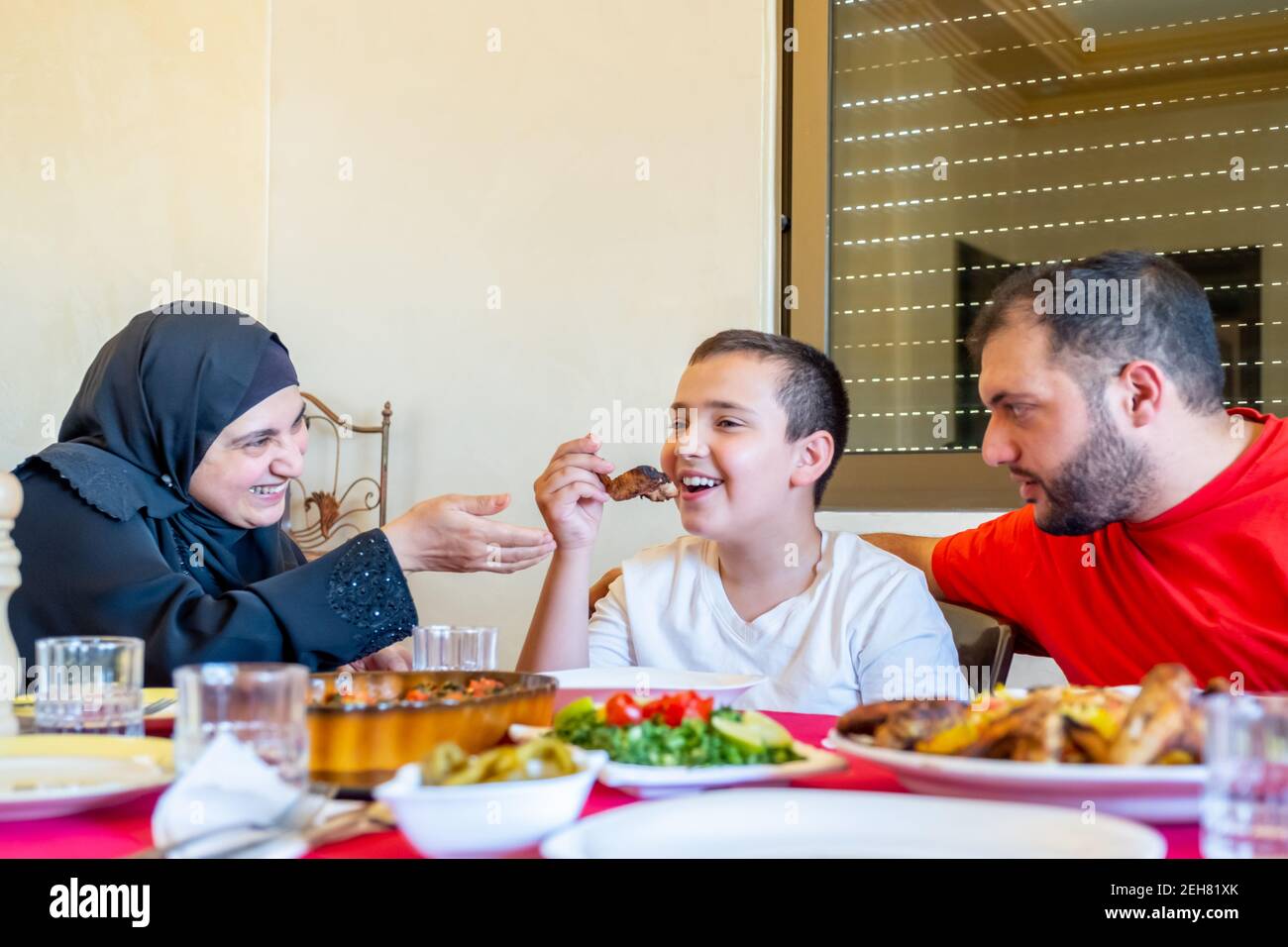 Arabic muslim family eating together in a meeting for iftar in ramdan ...