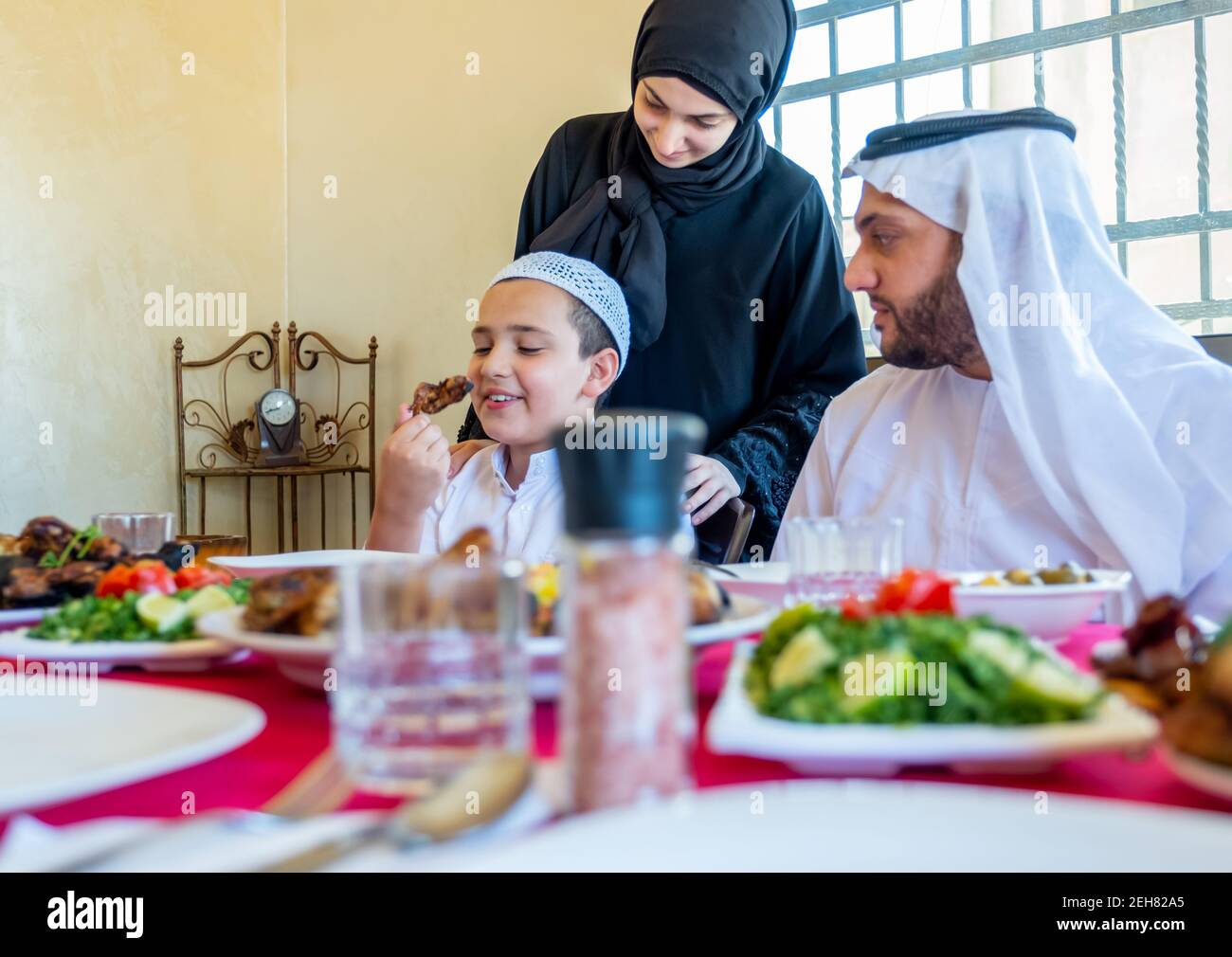 Arabic muslim family eating together in a meeting for iftar in ramdan ...