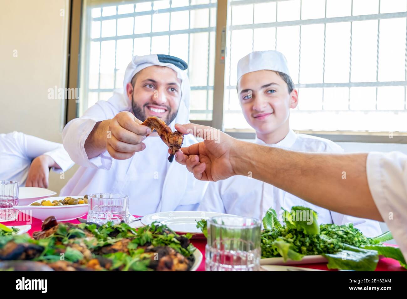 Arabic muslim family eating together in a meeting for iftar in ramdan ...