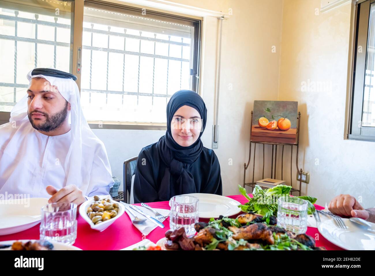 Happy arabic muslim family eating together in a family meeting for ...