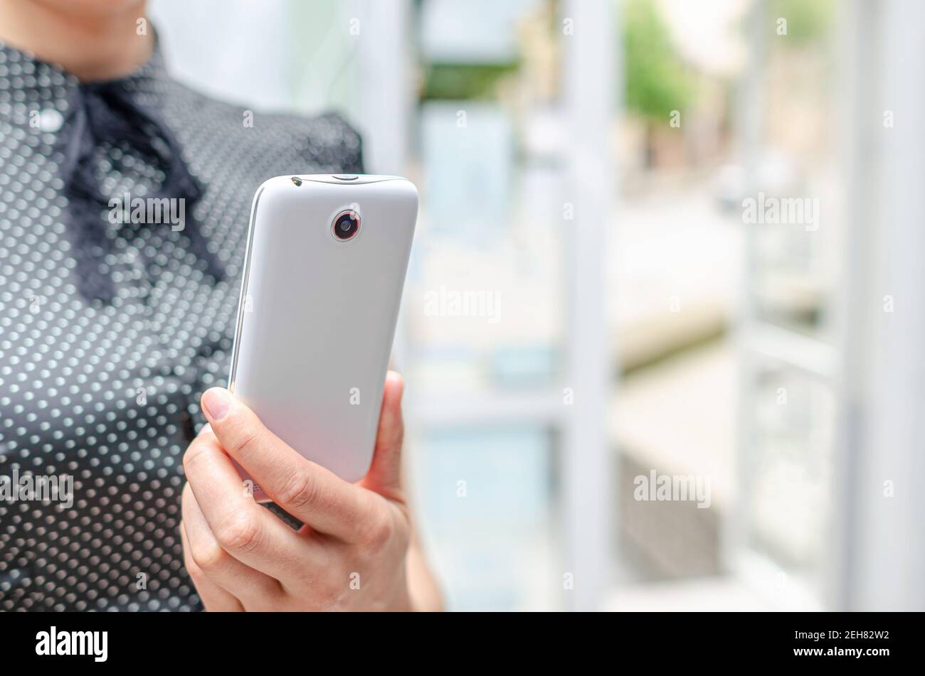 Smartphone in a female hand Stock Photo - Alamy