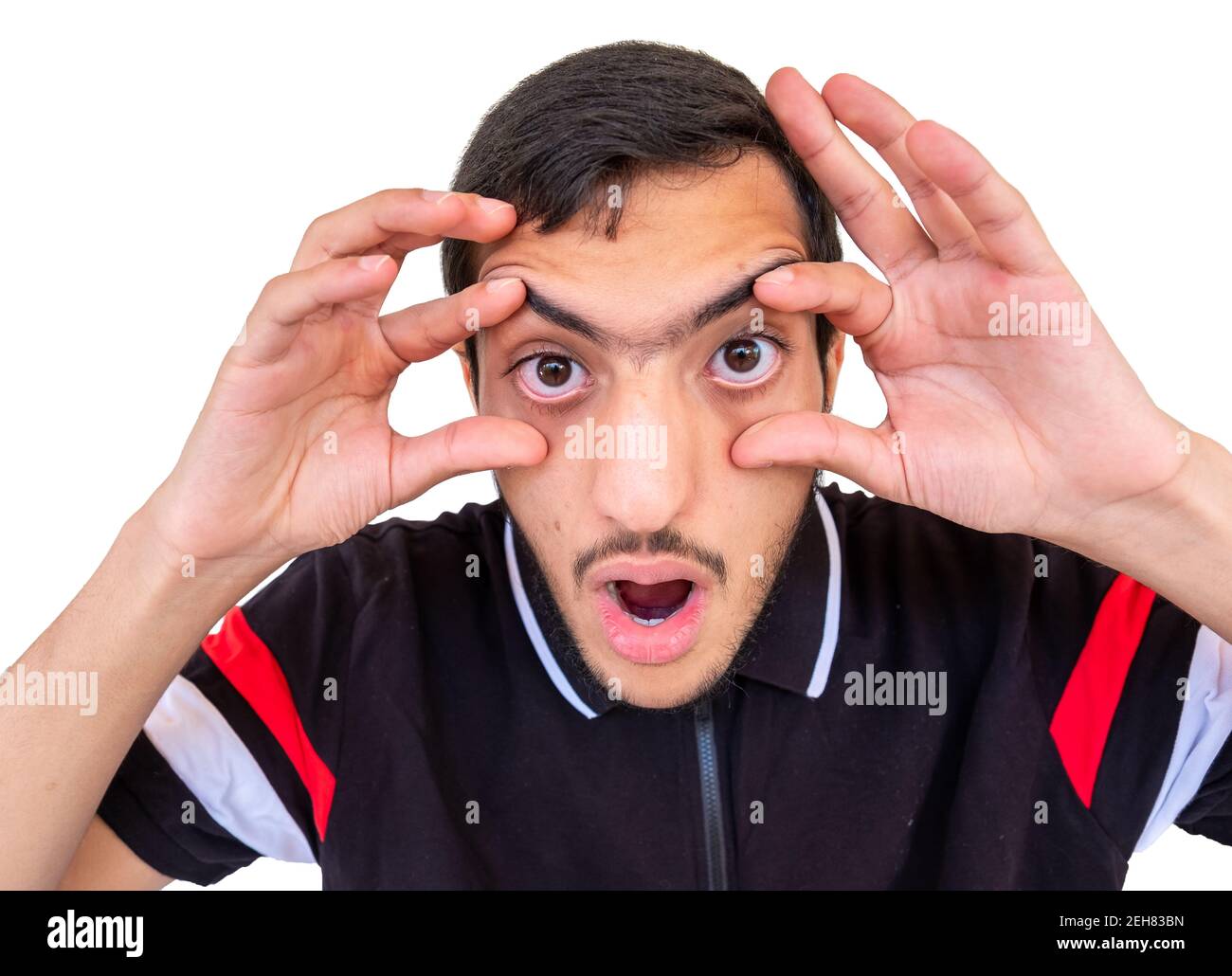 Middle eastern guy opening his eyes to stay awake Stock Photo - Alamy