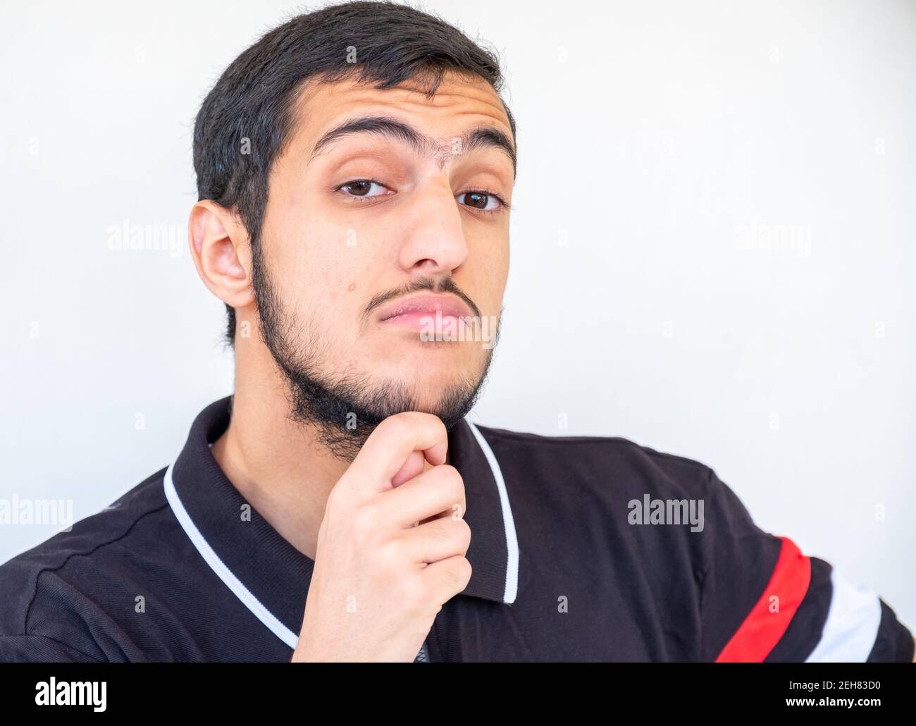 Arabic guy standing and thinking about ideas Stock Photo - Alamy