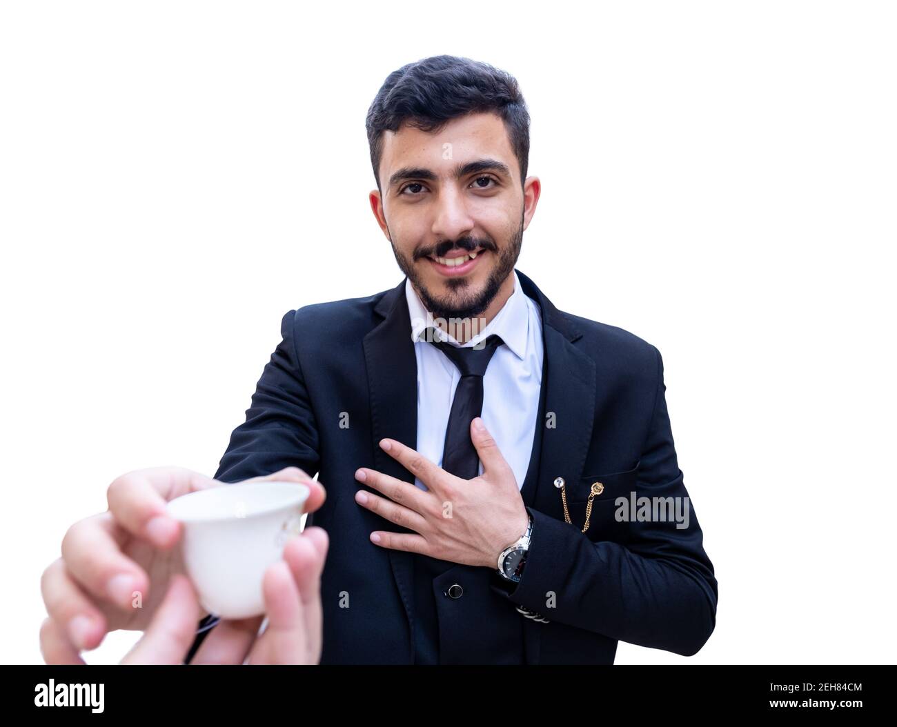 Arabian man wearing suit and holding a cup of Arabic coffee Stock Photo ...