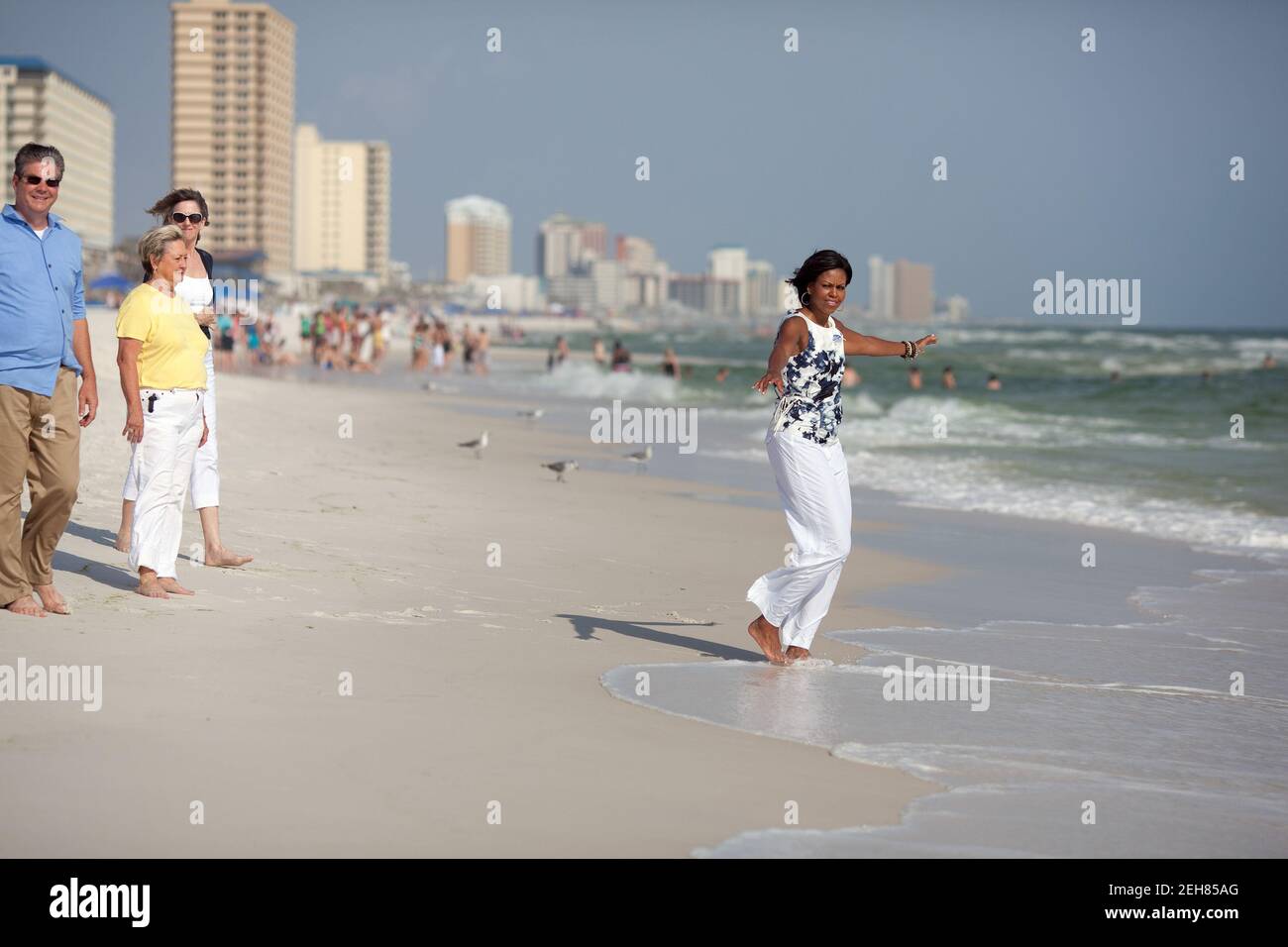 First Lady Michelle Obama walks along the beach with, from left, Dan ...