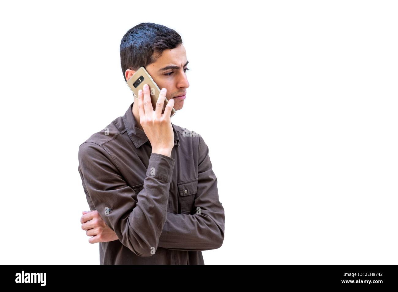 Arabic guy holding his smartphone Stock Photo - Alamy
