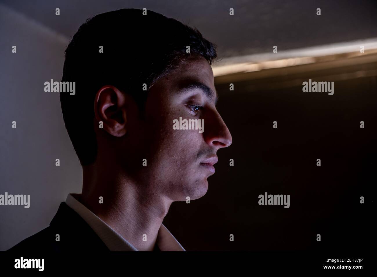 Arabic guy in dark room with light on his face and nice shadows Stock ...