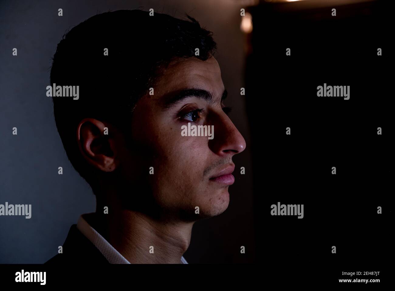 Arabic guy in dark room with light on his face and nice shadows Stock ...