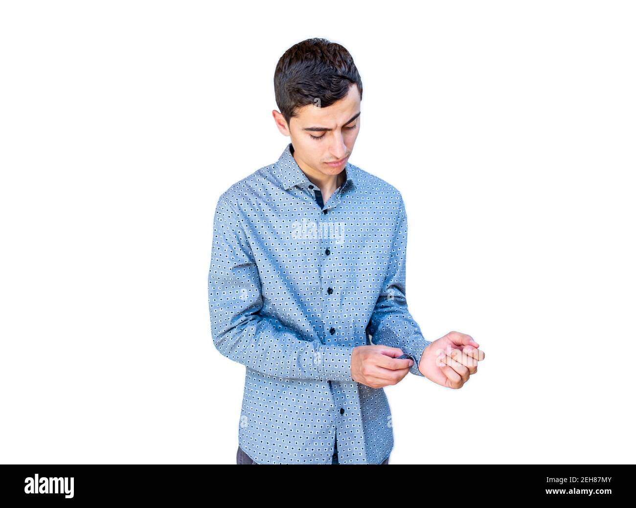 Young arabic guy doing his buttons Stock Photo - Alamy
