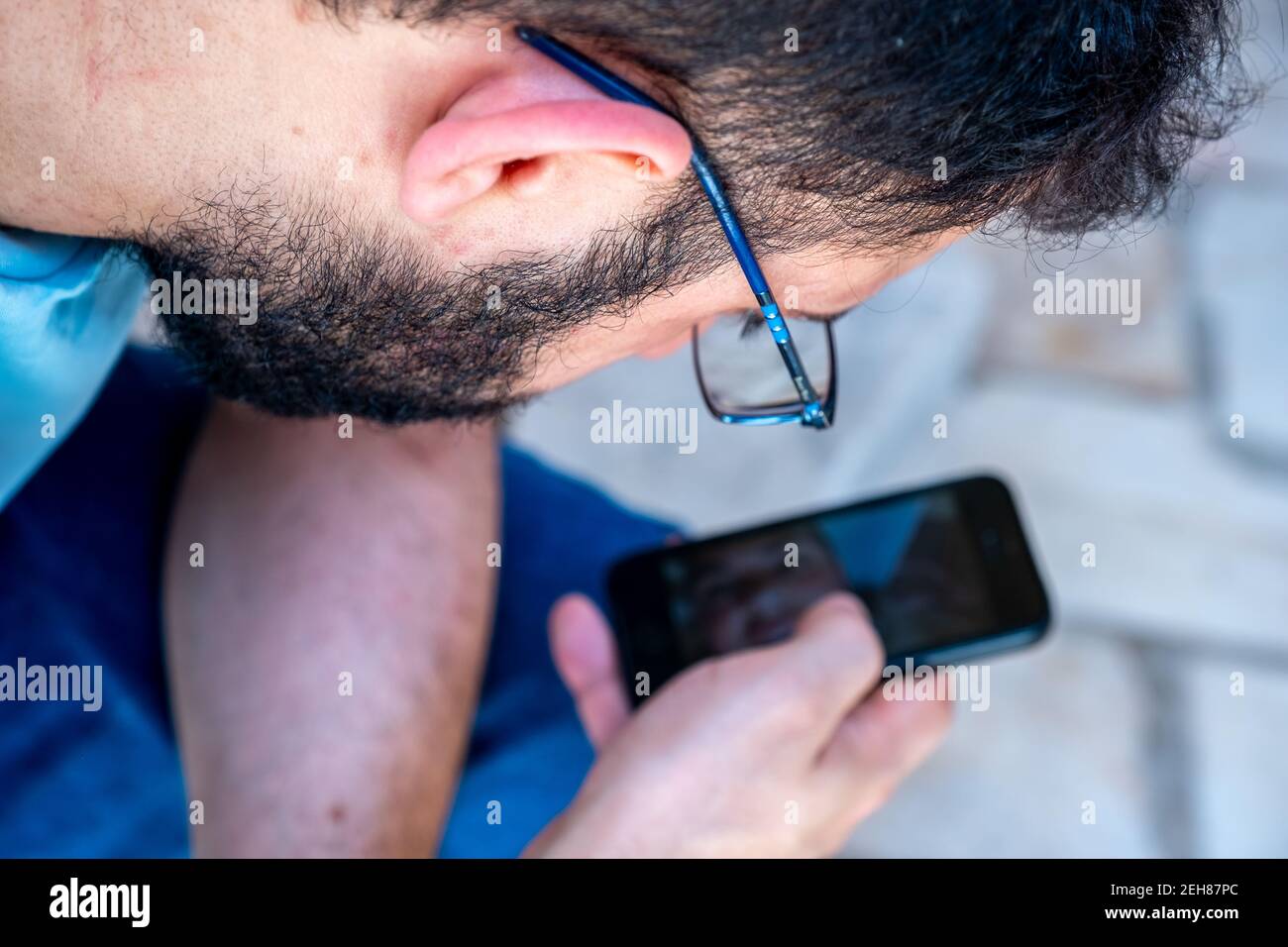 Arabic guy surfing internet on his smartphone Stock Photo - Alamy