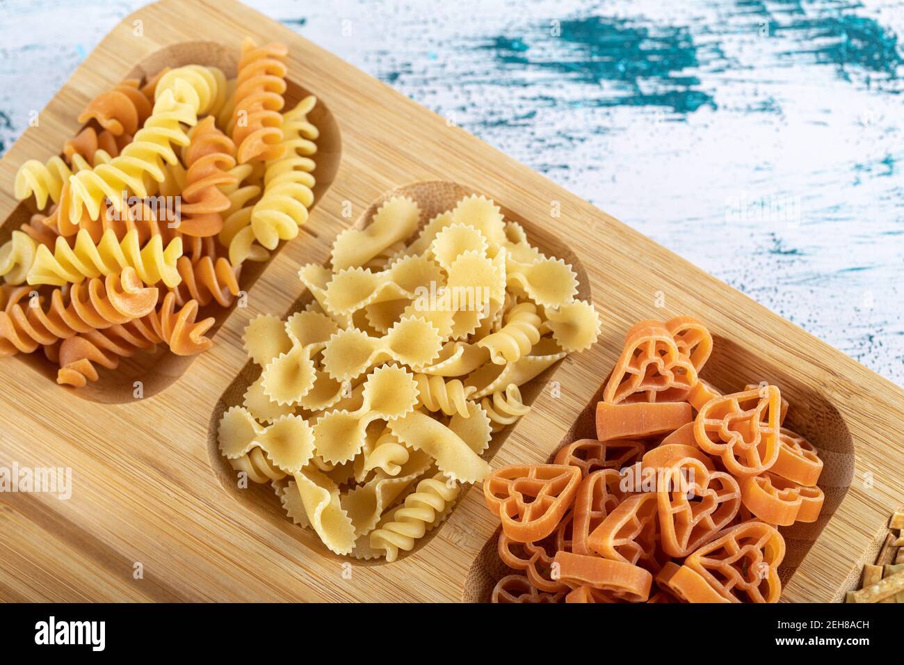 Three types of dry pasta placed on wooden plate Stock Photo - Alamy