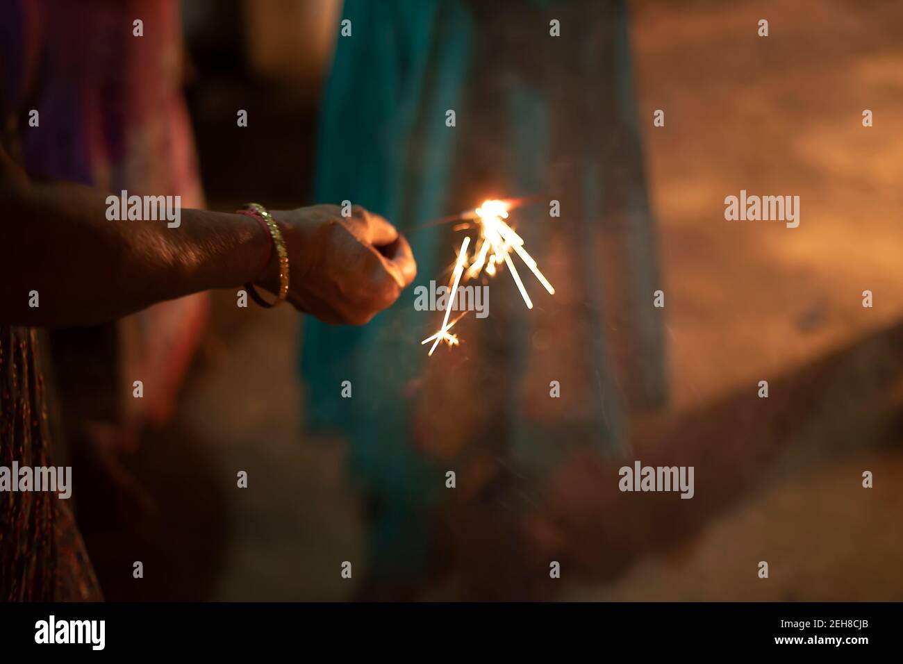 Hand holding firecracker night people hi-res stock photography and ...
