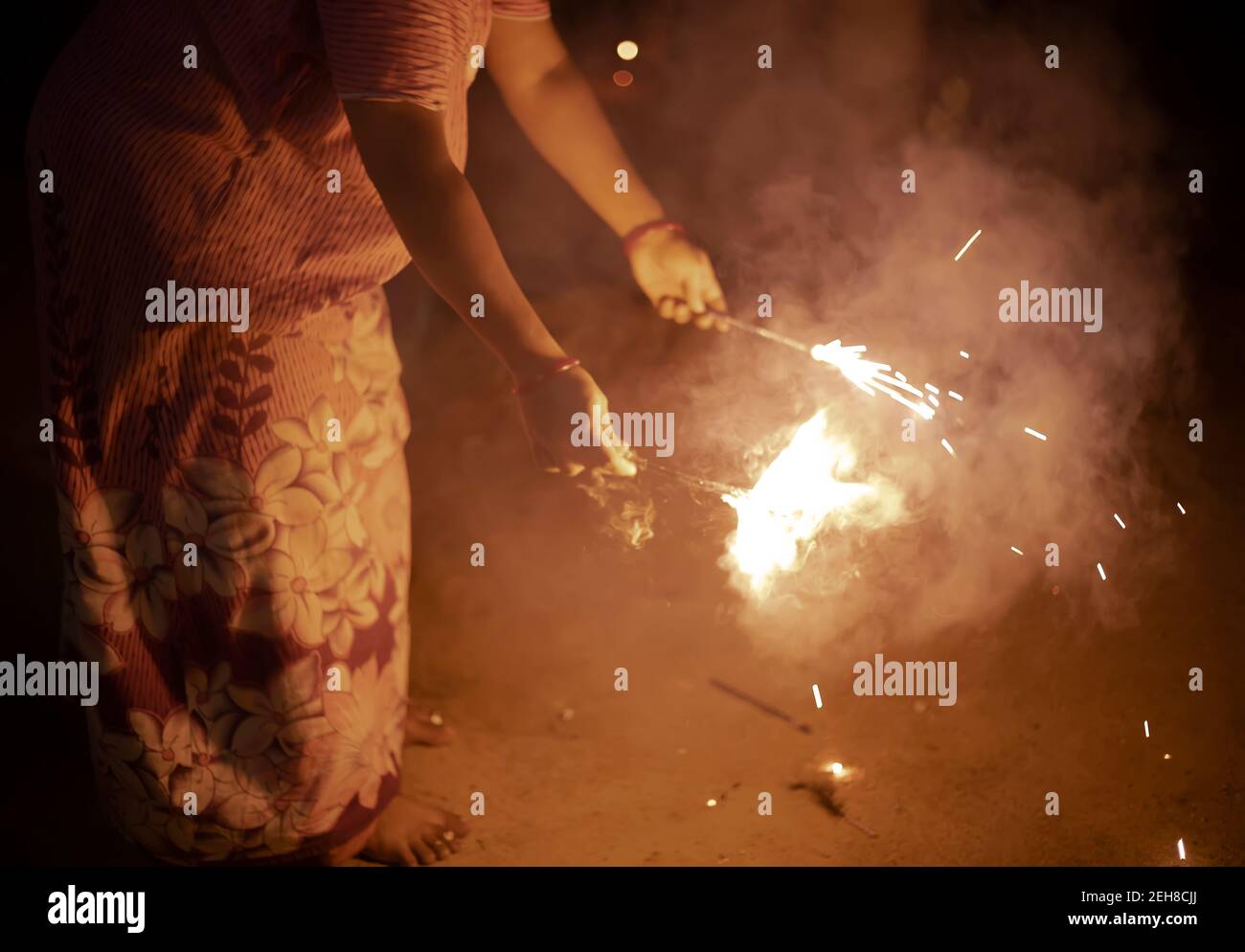 Hand holding firecracker night people hi-res stock photography and ...