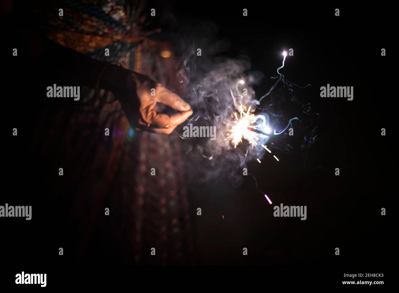 Hand holding firecracker night people hi-res stock photography and ...
