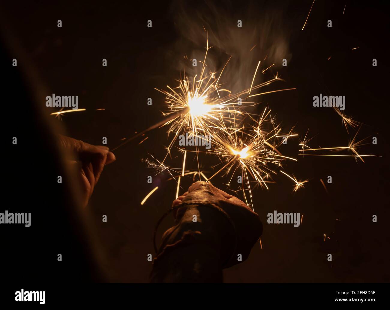An Indian woman holding a firecracker Stock Photo - Alamy