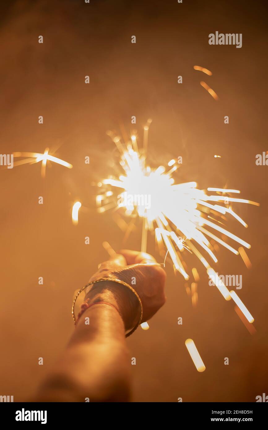 Hand holding firecracker night people hi-res stock photography and ...