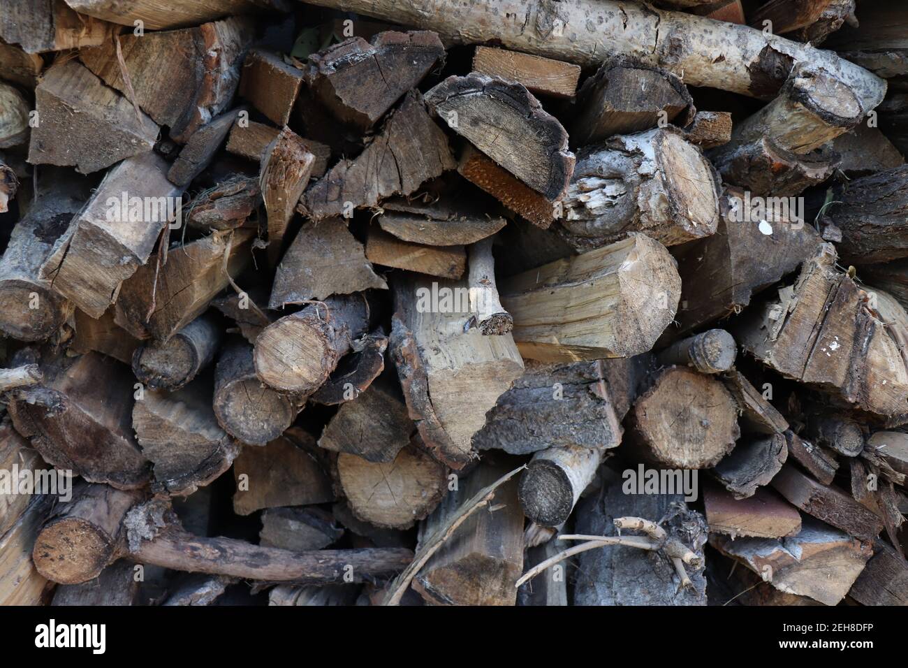 a lot of firewood, stack of firewood, stacked firewood in a big pile ...