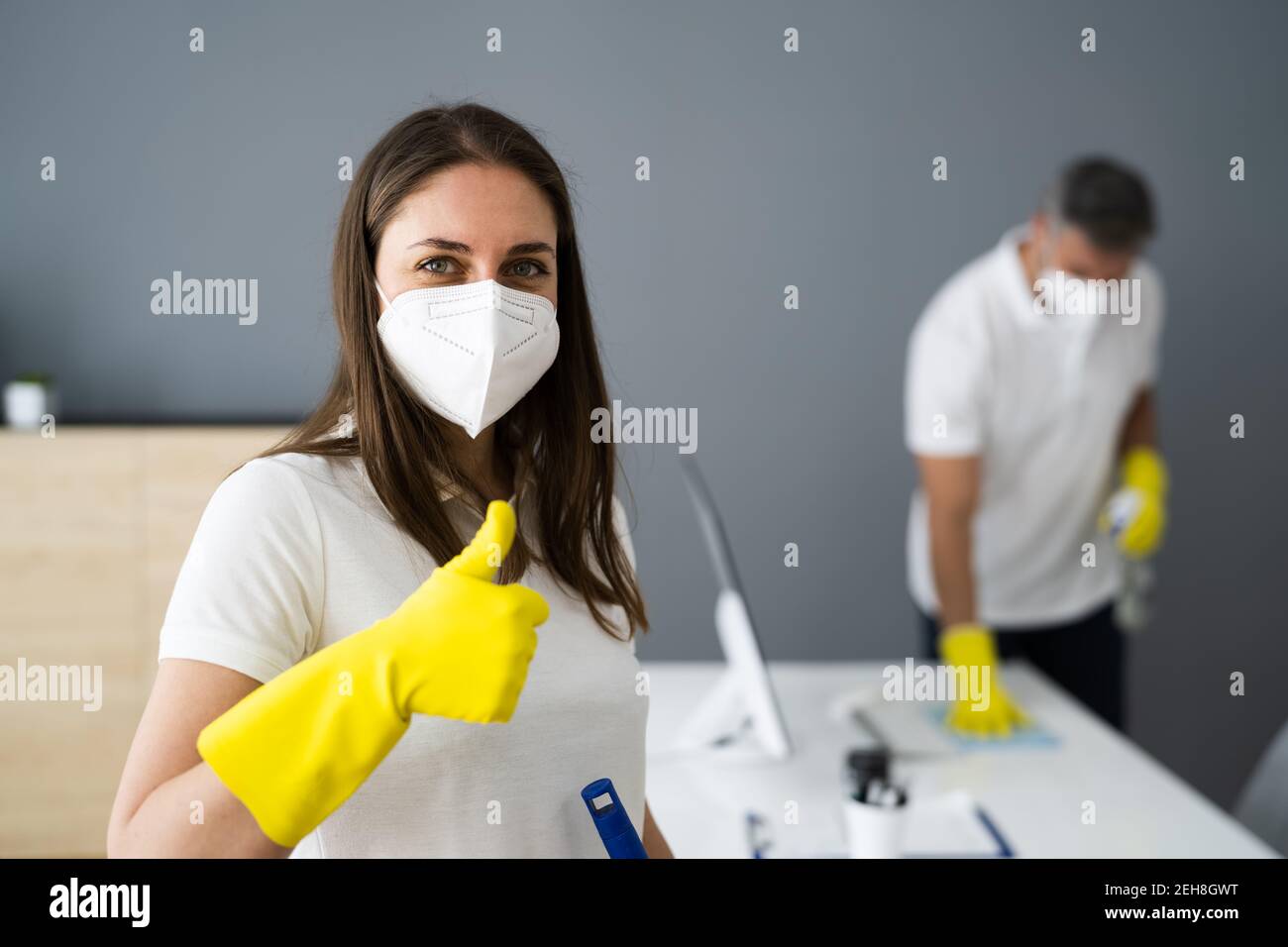 Cleaning Service Janitor Near Desk In Covid Face Mask Stock Photo - Alamy