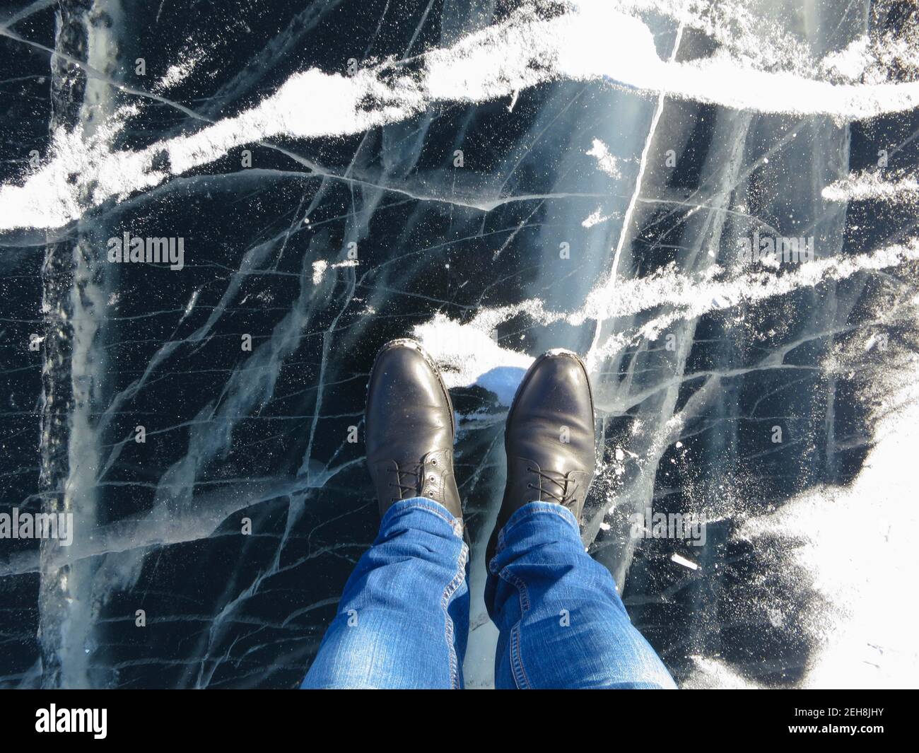 Lake Baikal in winter -ice and feet in shoes 2021 Stock Photo - Alamy