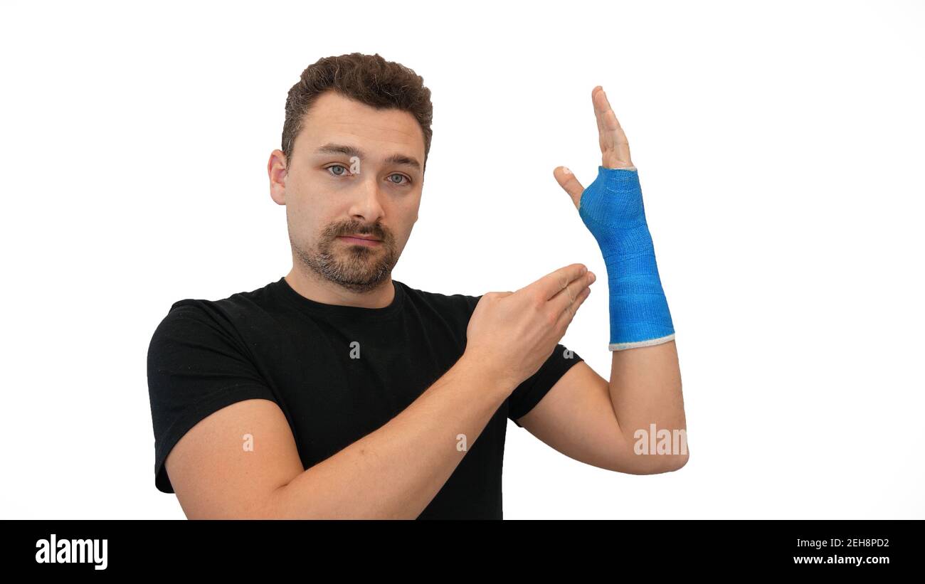 Man shows plaster cast on white background Stock Photo - Alamy