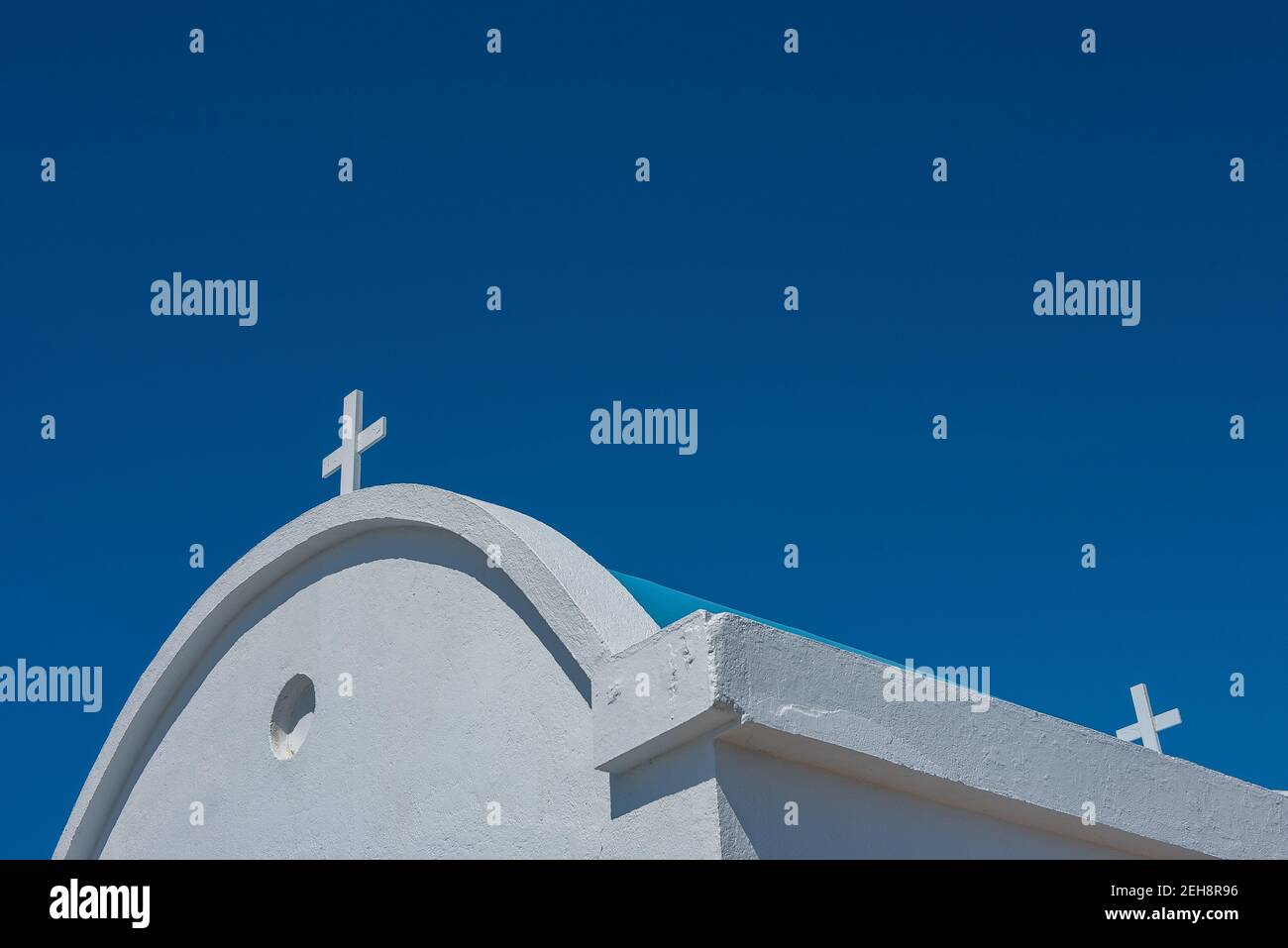 Traditional Greek white chapel with a blue roof on the seaside. Agioi ...