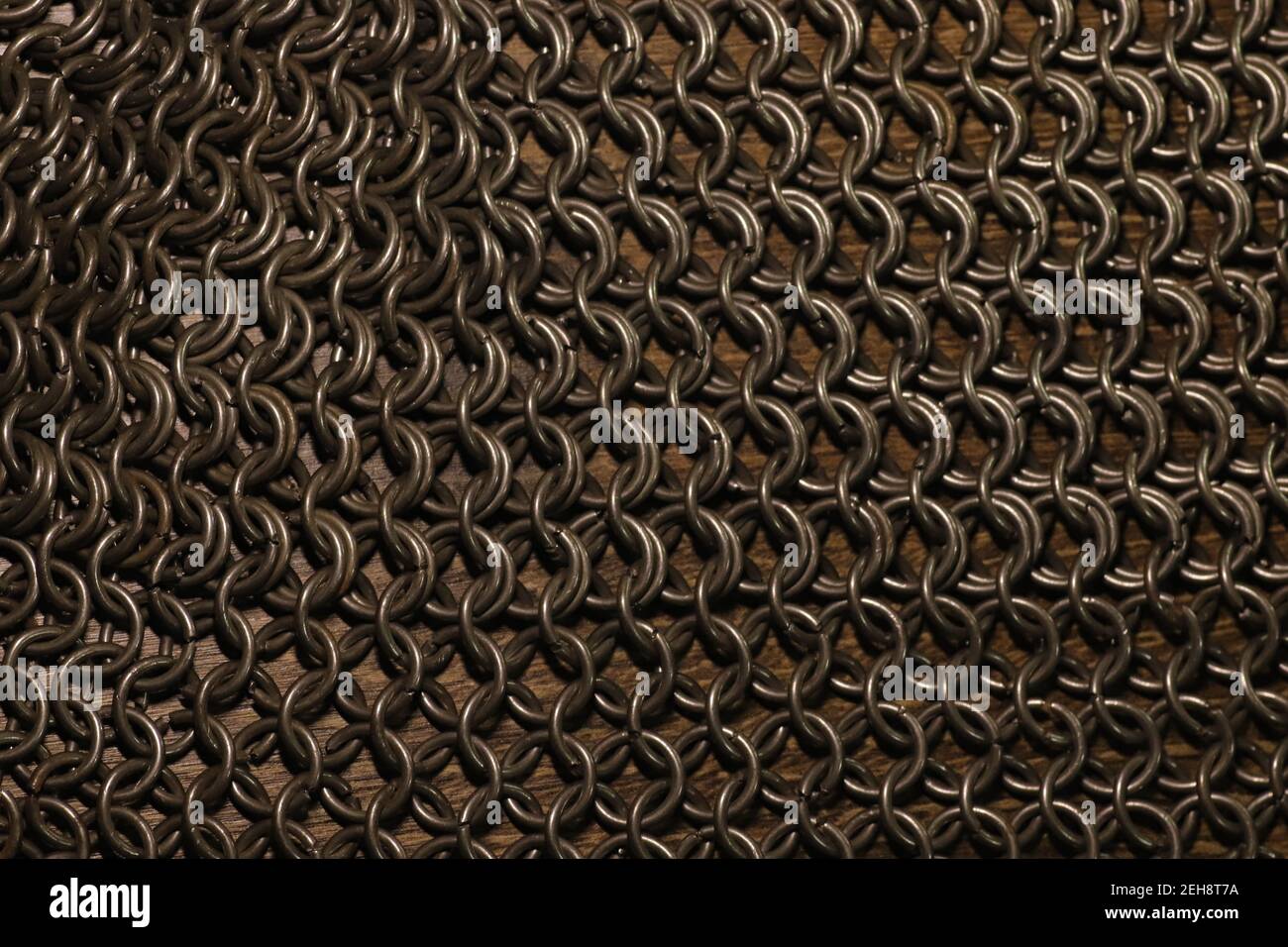 chain mail cloth, steel rings on wood surface Stock Photo - Alamy