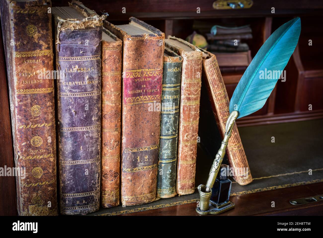 old books on desk and pen writing Stock Photo - Alamy