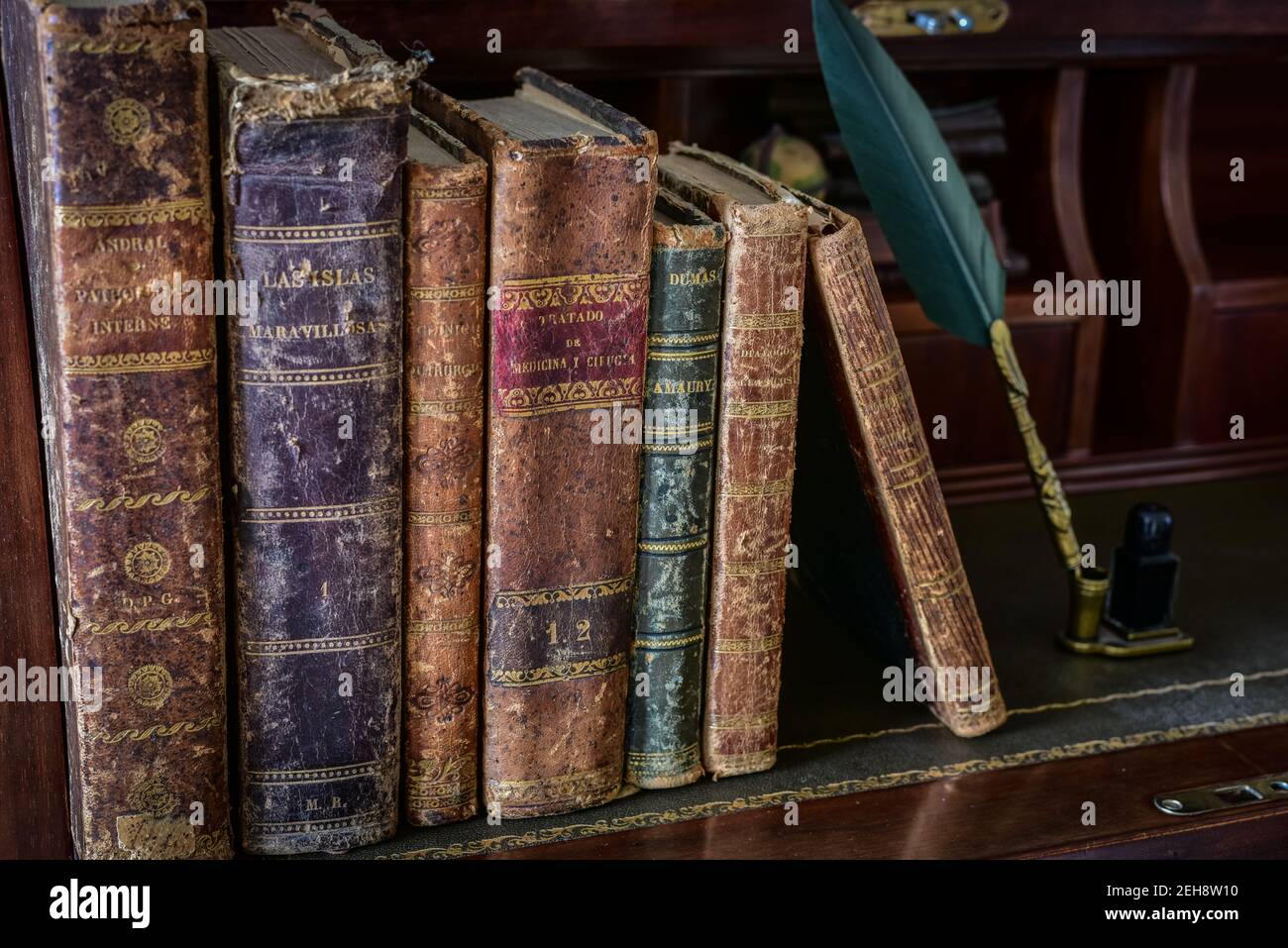 old books on desk and pen writing Stock Photo - Alamy