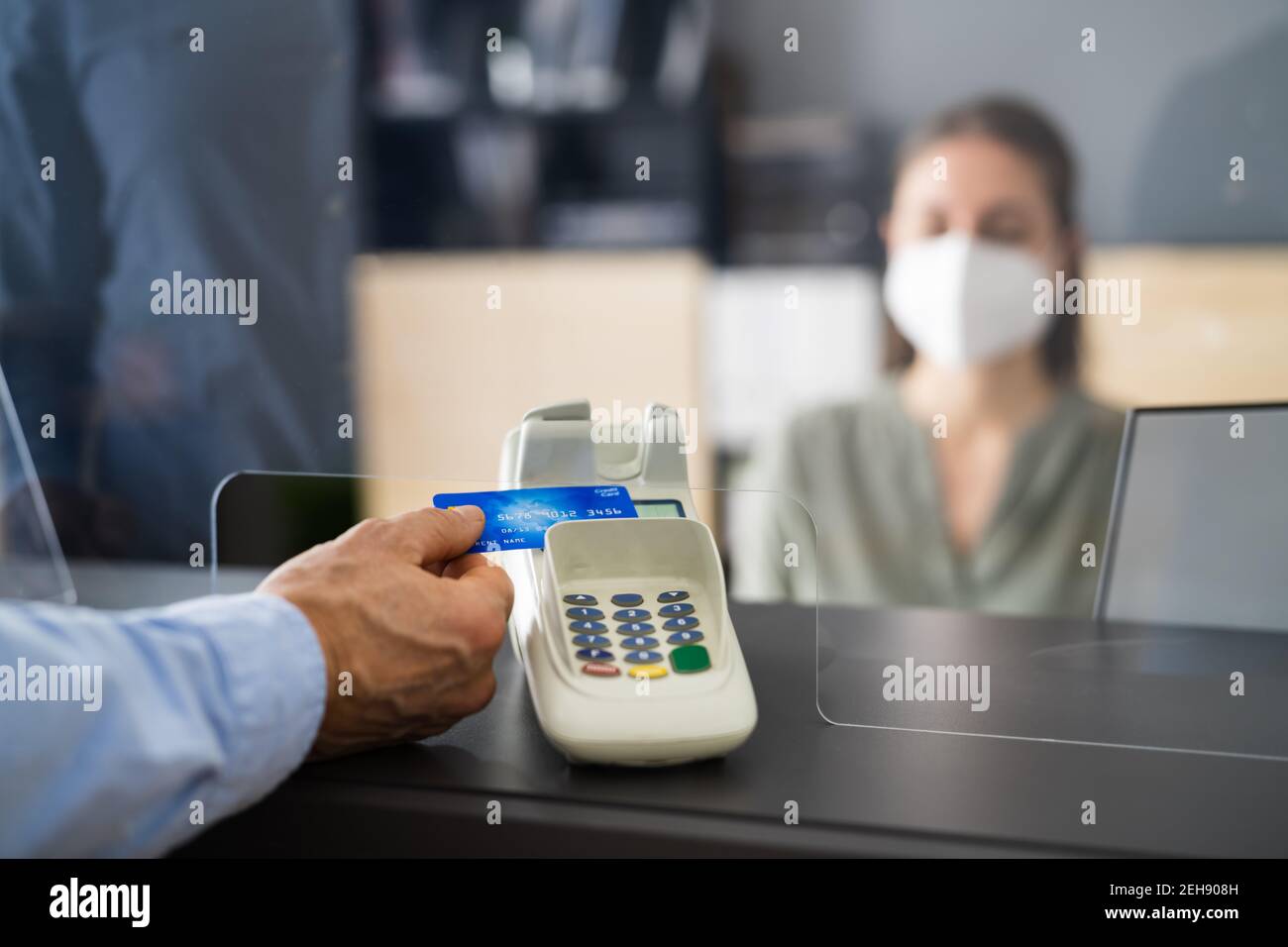 Contactless Hotel Reception Payment In Face Mask Stock Photo - Alamy