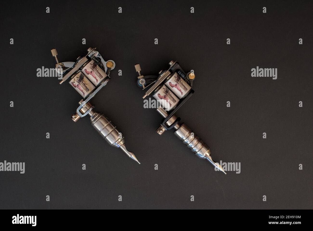 tattoo machines on black background Stock Photo - Alamy