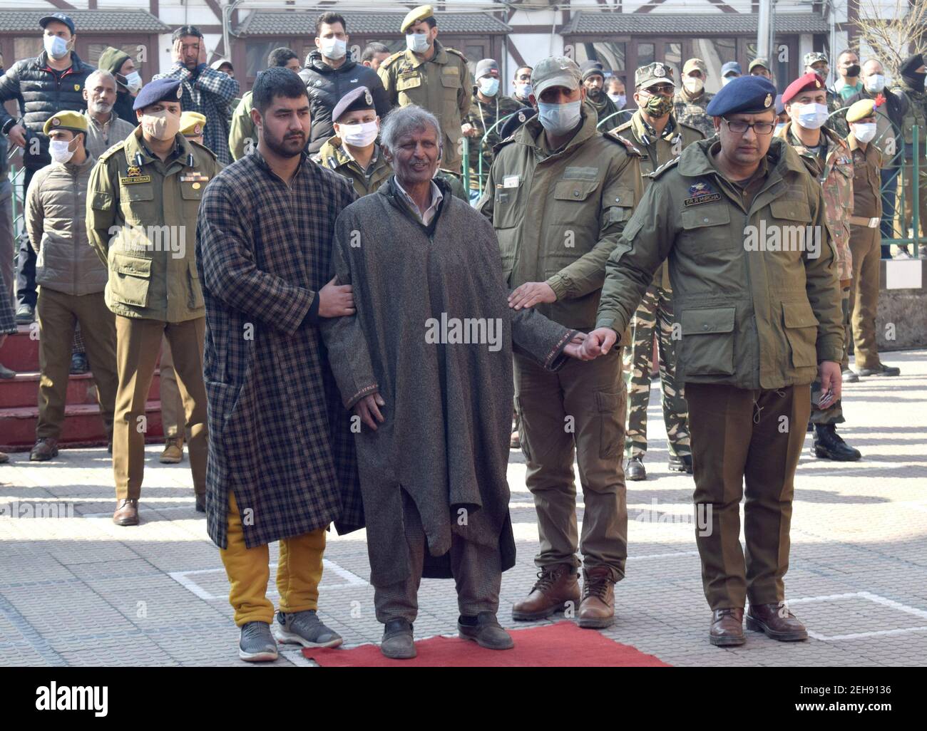 Srinagar, 19th February 2021. The father of the killed policeman lays a ...