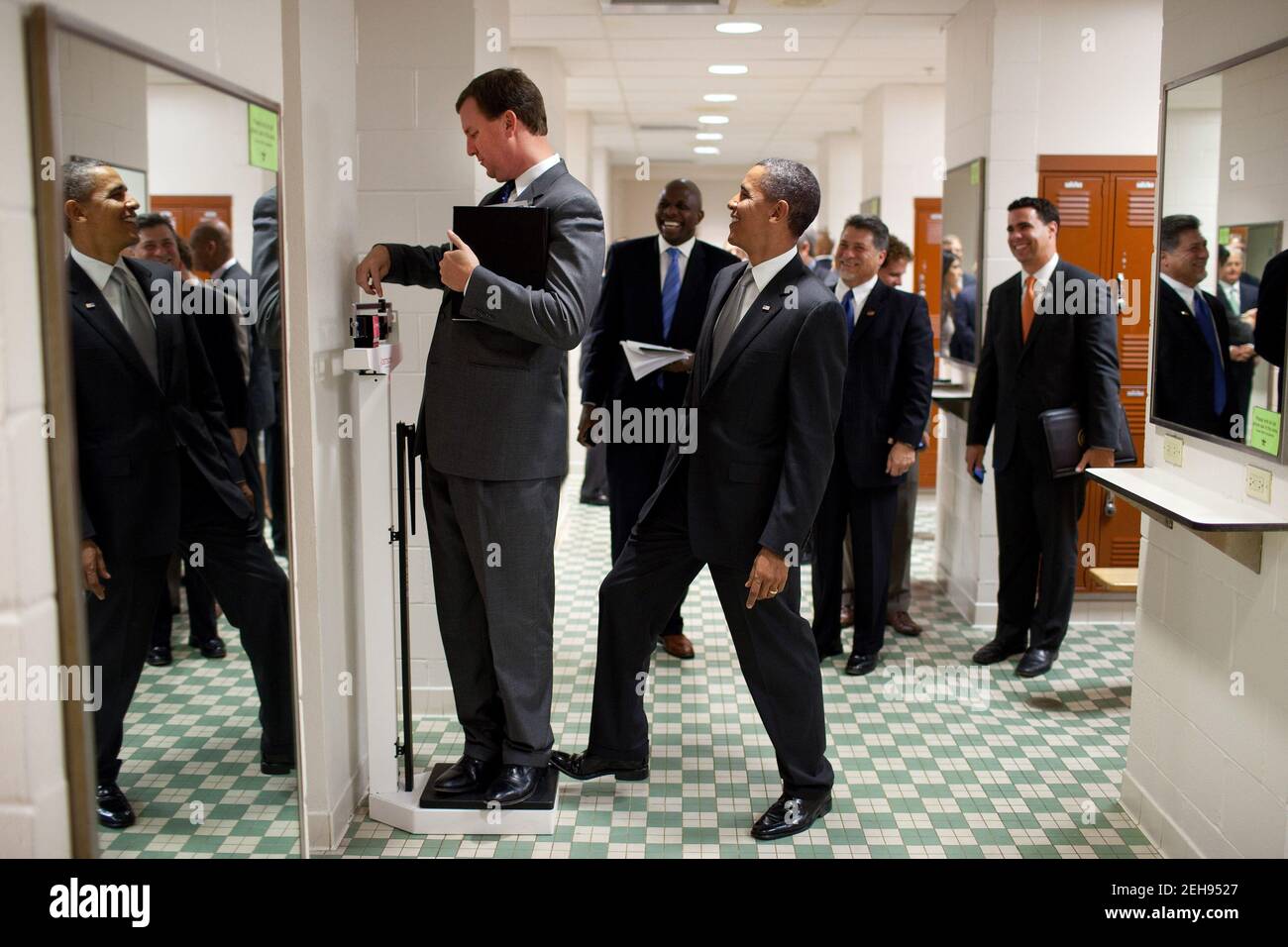 President Barack Obama jokingly puts his toe on the scale as Trip ...